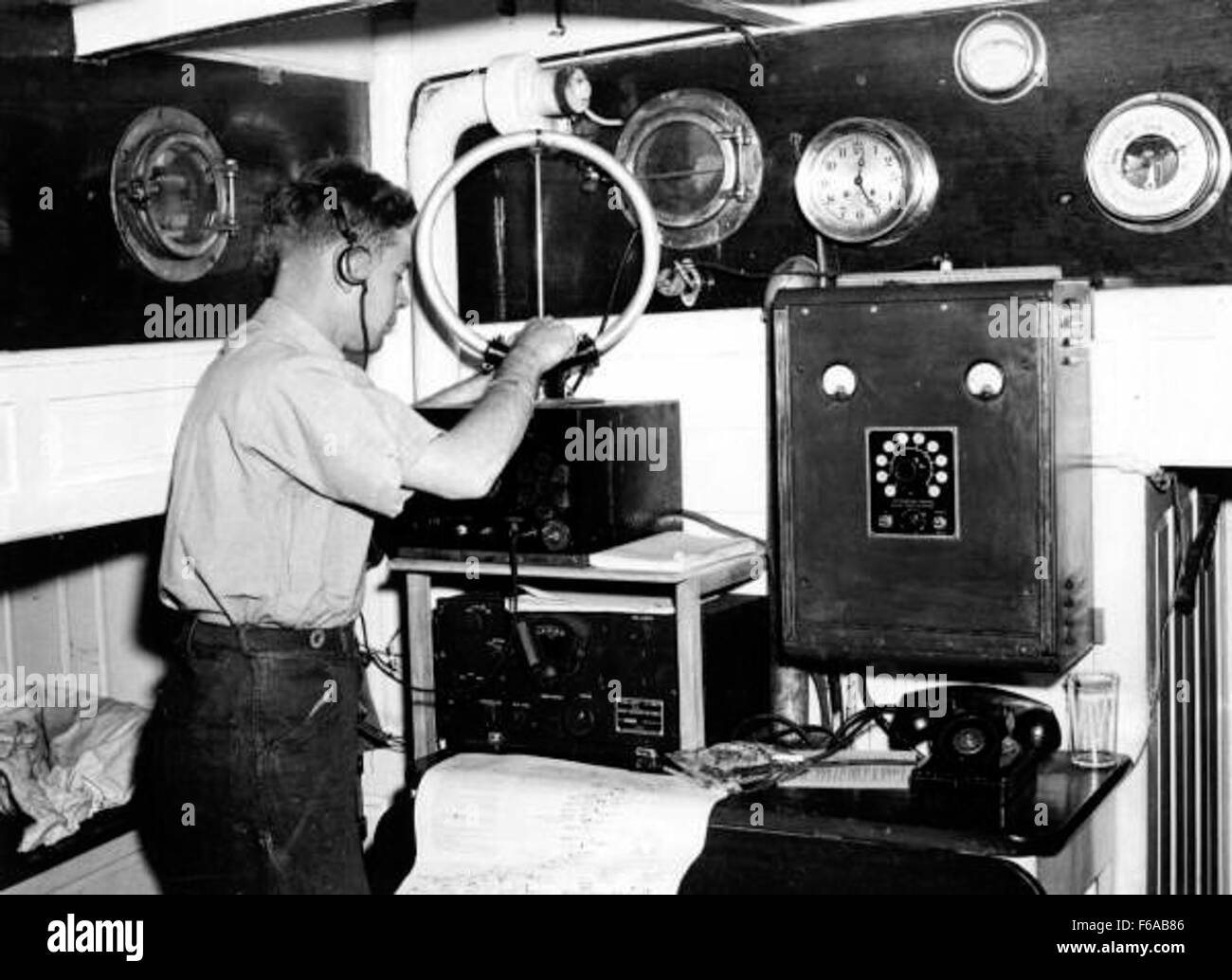 This photo shows an operator using radio equipment on a sailboat in ...