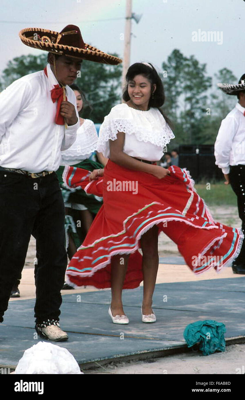 This image captures performers dancing at a fiesta, showcasing ...
