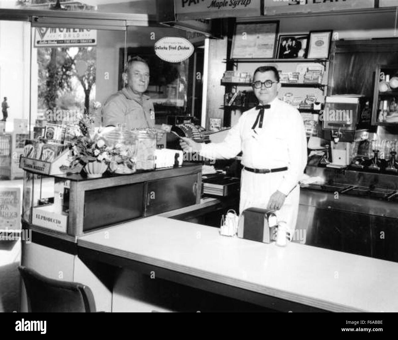 Tommy Holland, likely an owner or employee, is assisting a customer at ...