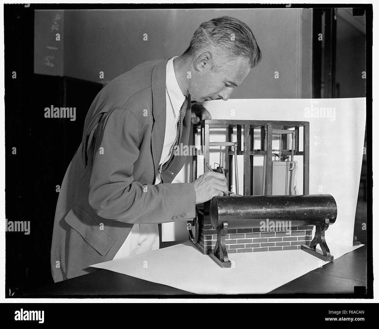 This image shows a man posing with the patent model of the Gorrie Ice ...