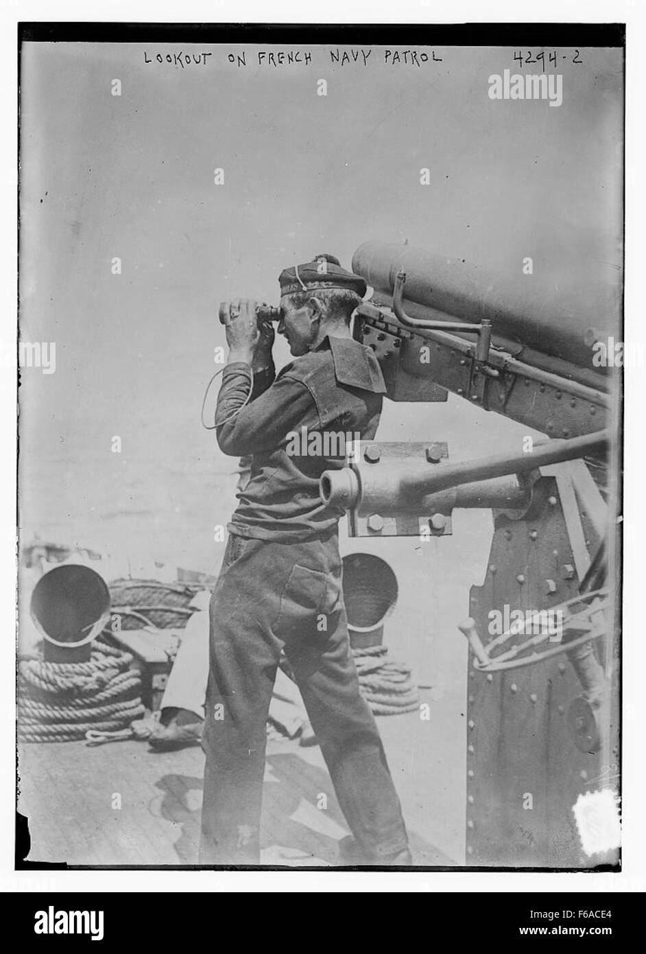 A lookout on a French Navy patrol ship observes the surrounding waters ...