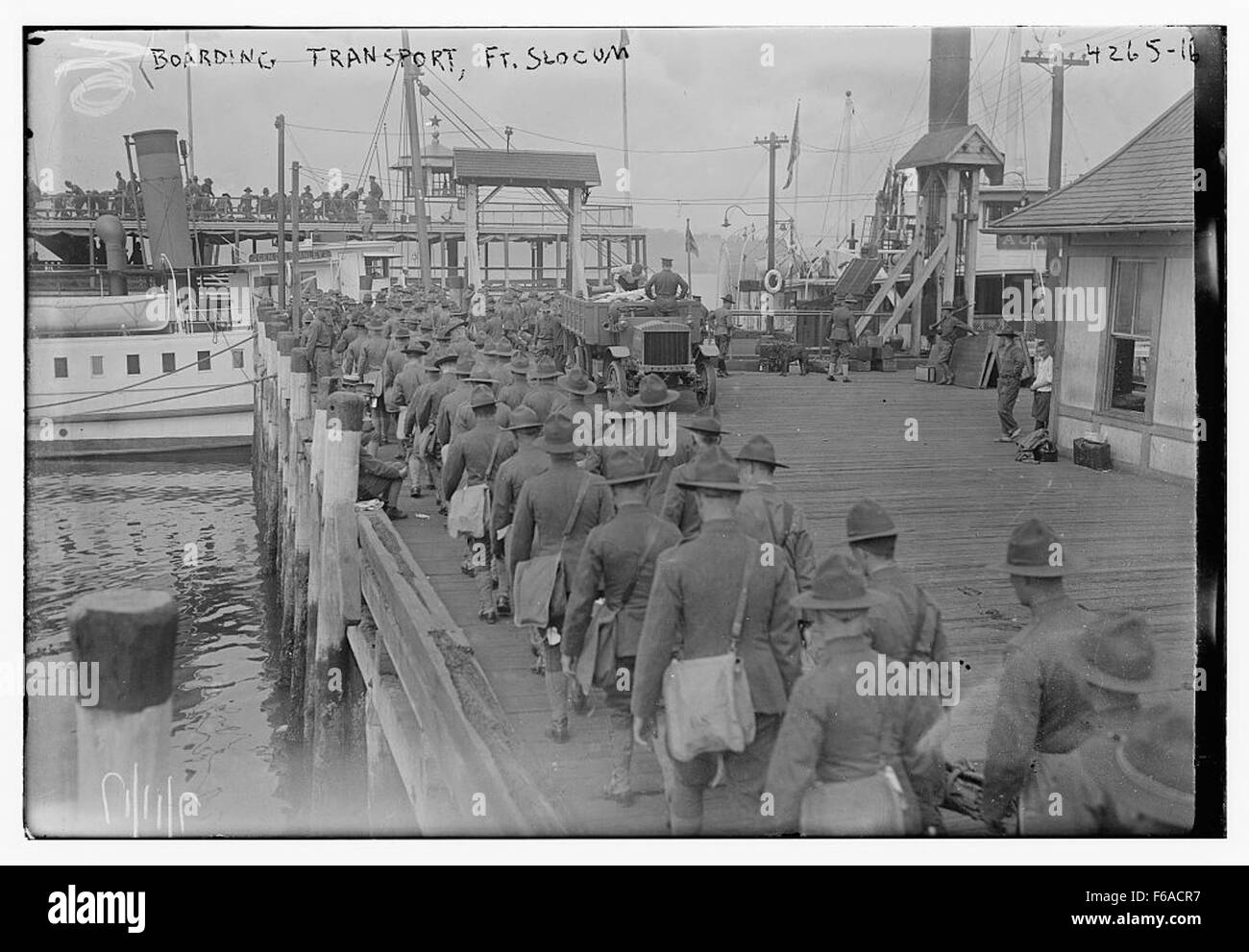 A historic image showing individuals boarding transport at Fort Slocum ...