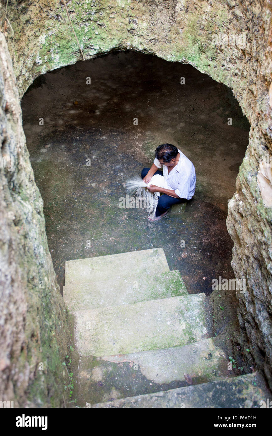 An artisan weaver begins work on a panama hat in a cave in Becal ...