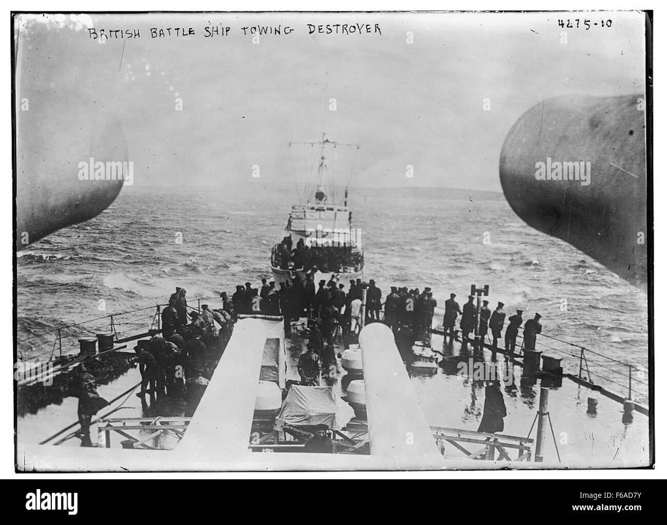 A British battleship is seen towing a destroyer, highlighting the power ...