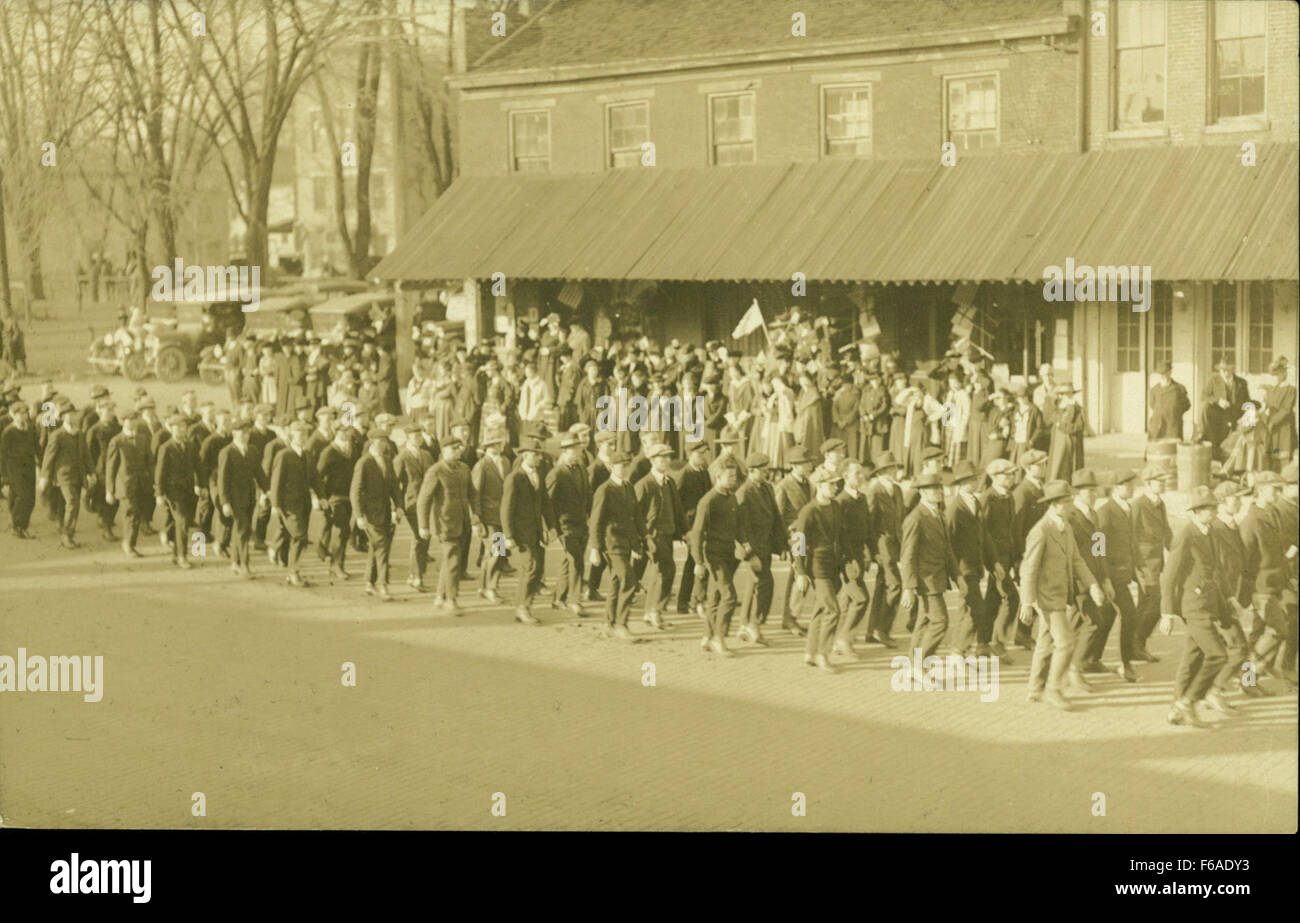 A photograph of men marching, likely in a parade or military procession ...