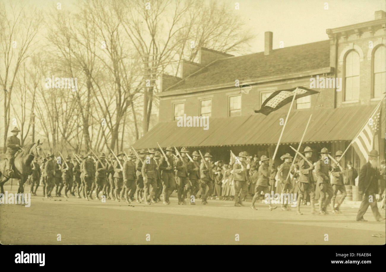 A photograph depicting a parade of soldiers, likely from a wartime ...