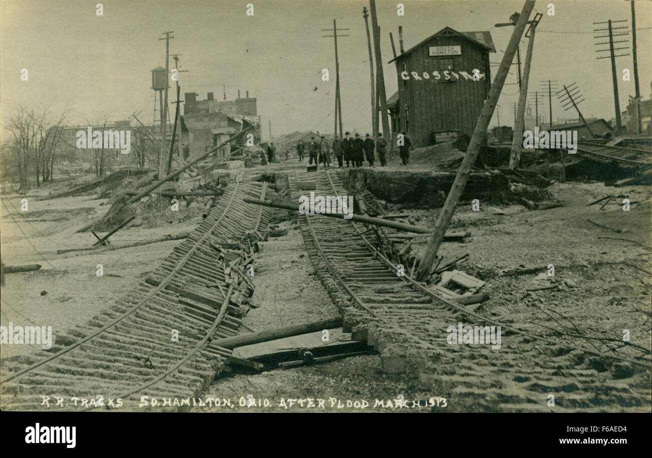 A photograph of the damage caused by floods to railroad tracks and cars ...