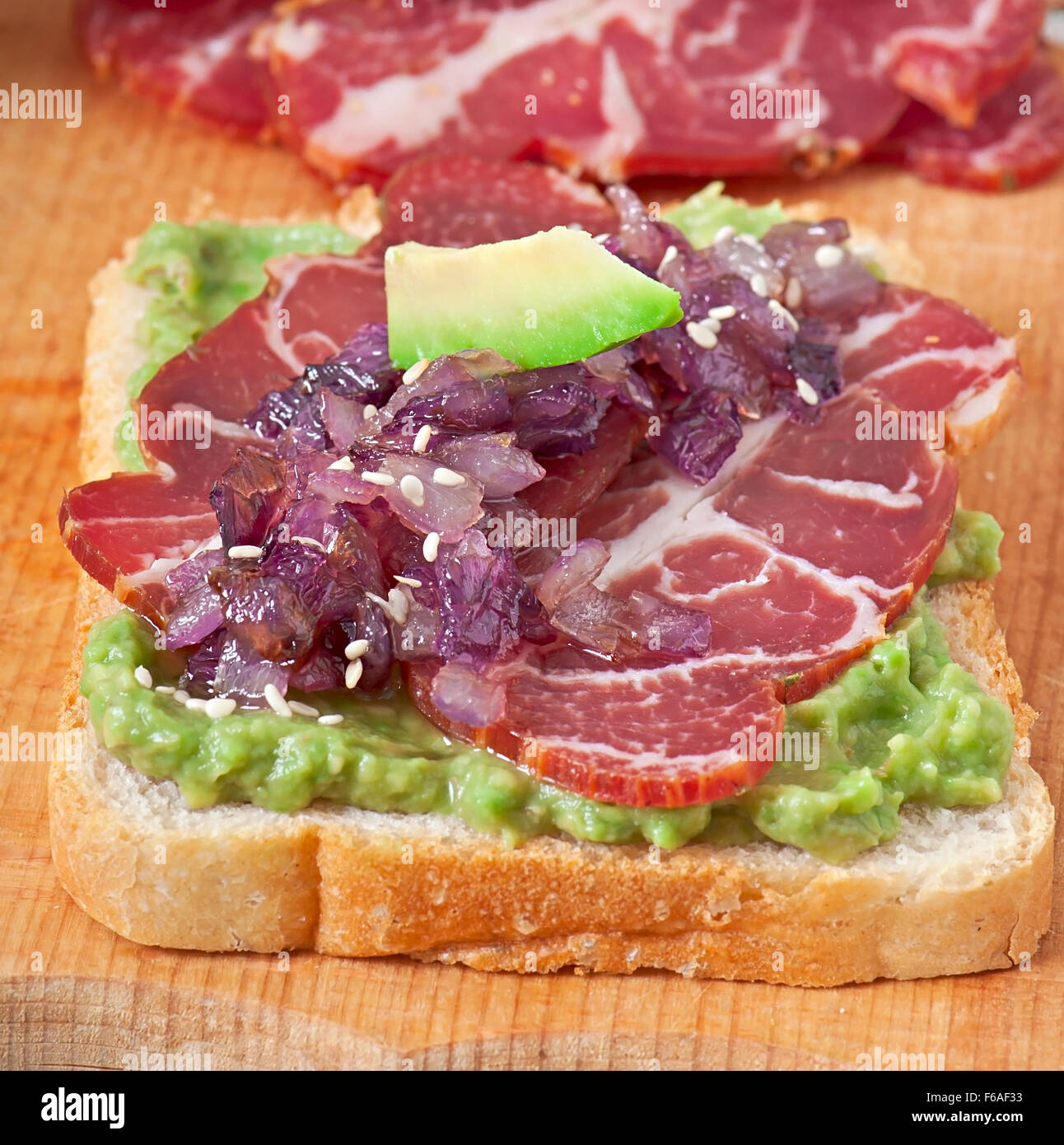 Sandwich with ham, avocado sauce and caramelized onions Stock Photo - Alamy