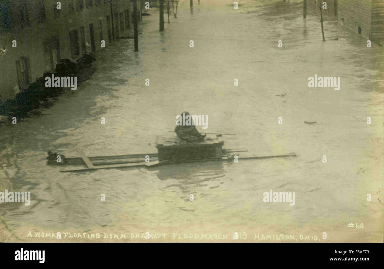 A woman is seen floating on a raft during a rescue operation following ...