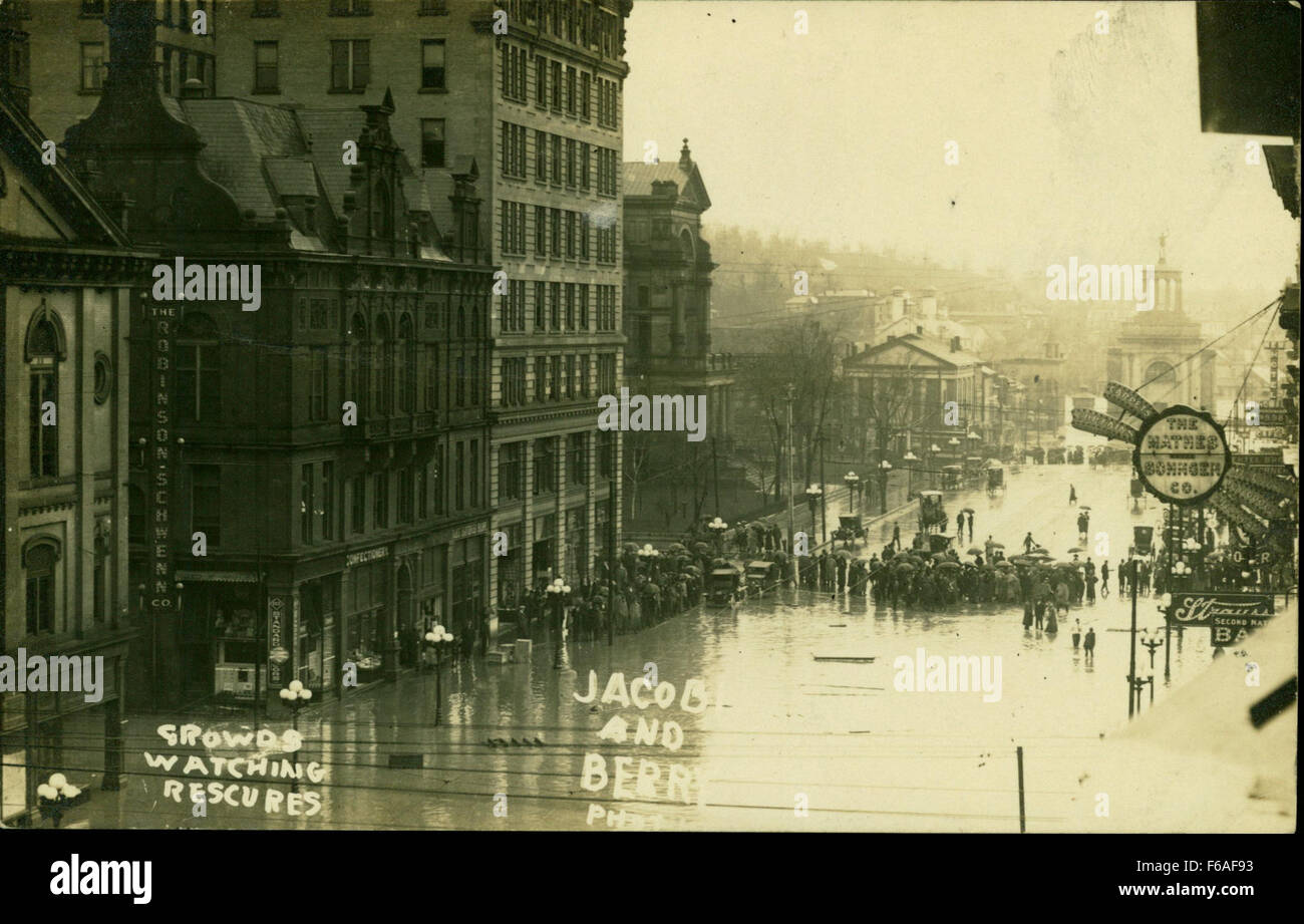 A photograph of crowds gathered to watch rescuers in action, likely ...