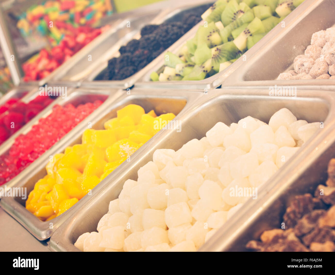Frozen yogurt toppings bar. Yogurt toppings ranging from fresh fruits ...