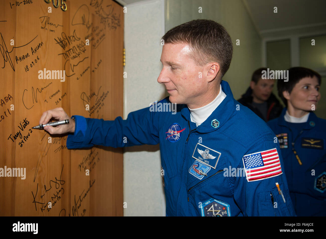 NASA astronaut Terry Virts signs the door at the Cosmonaut Hotel in ...