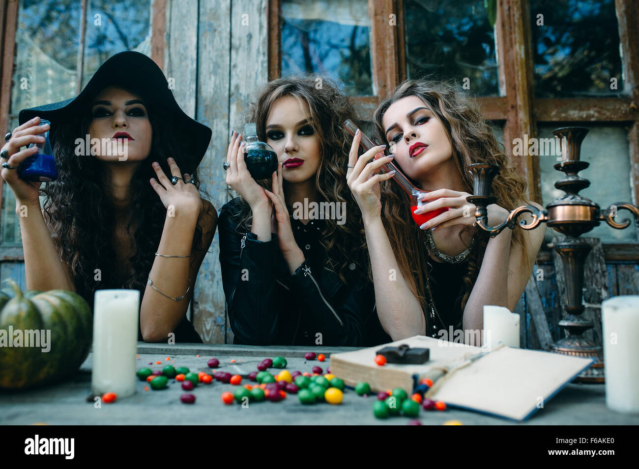 three witches at the table Stock Photo - Alamy