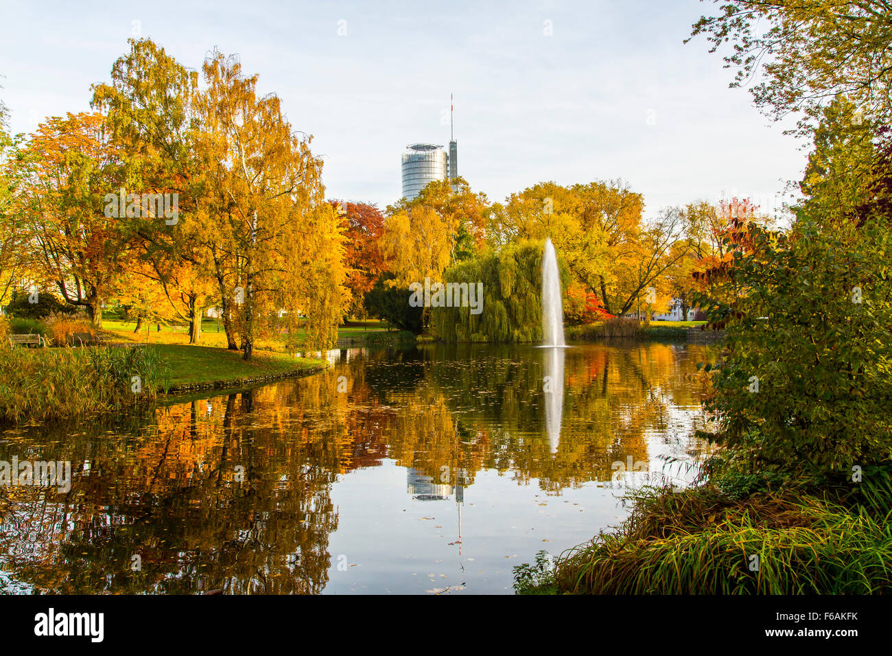 City park in Essen, Germany, pond and water fountain, RWE headquarter ...