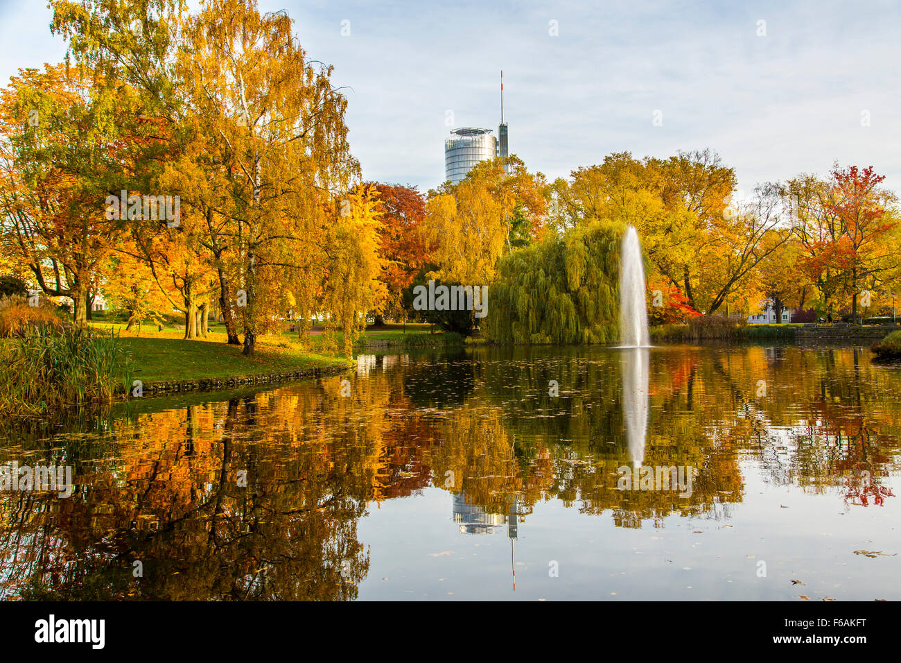 City park in Essen, Germany, pond and water fountain, RWE headquarter ...