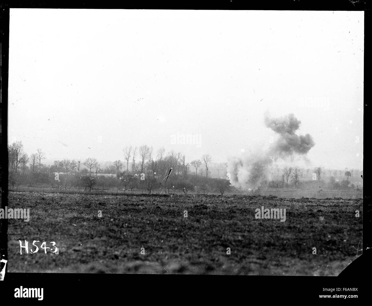A military photograph depicting a shell burst from artillery near the ...