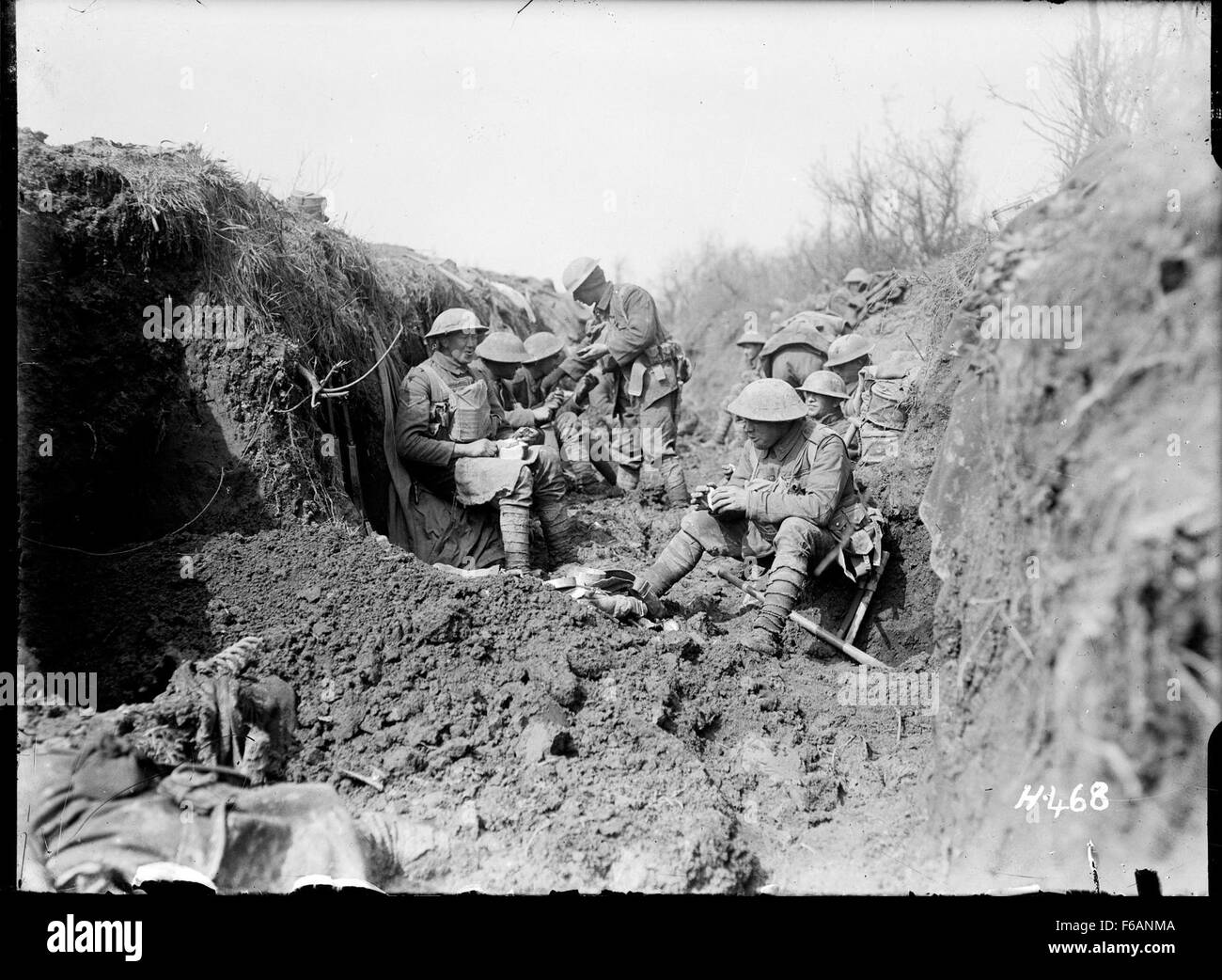 A historical image showing soldiers eating in the front-line trench ...
