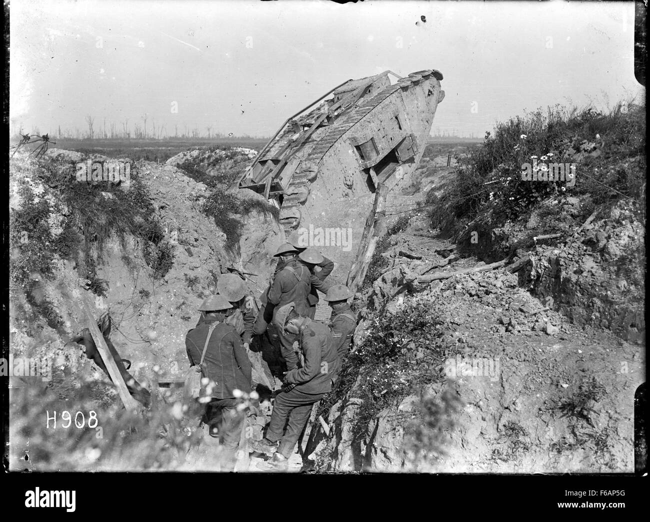 This historical photograph shows New Zealand troops, along with a tank ...