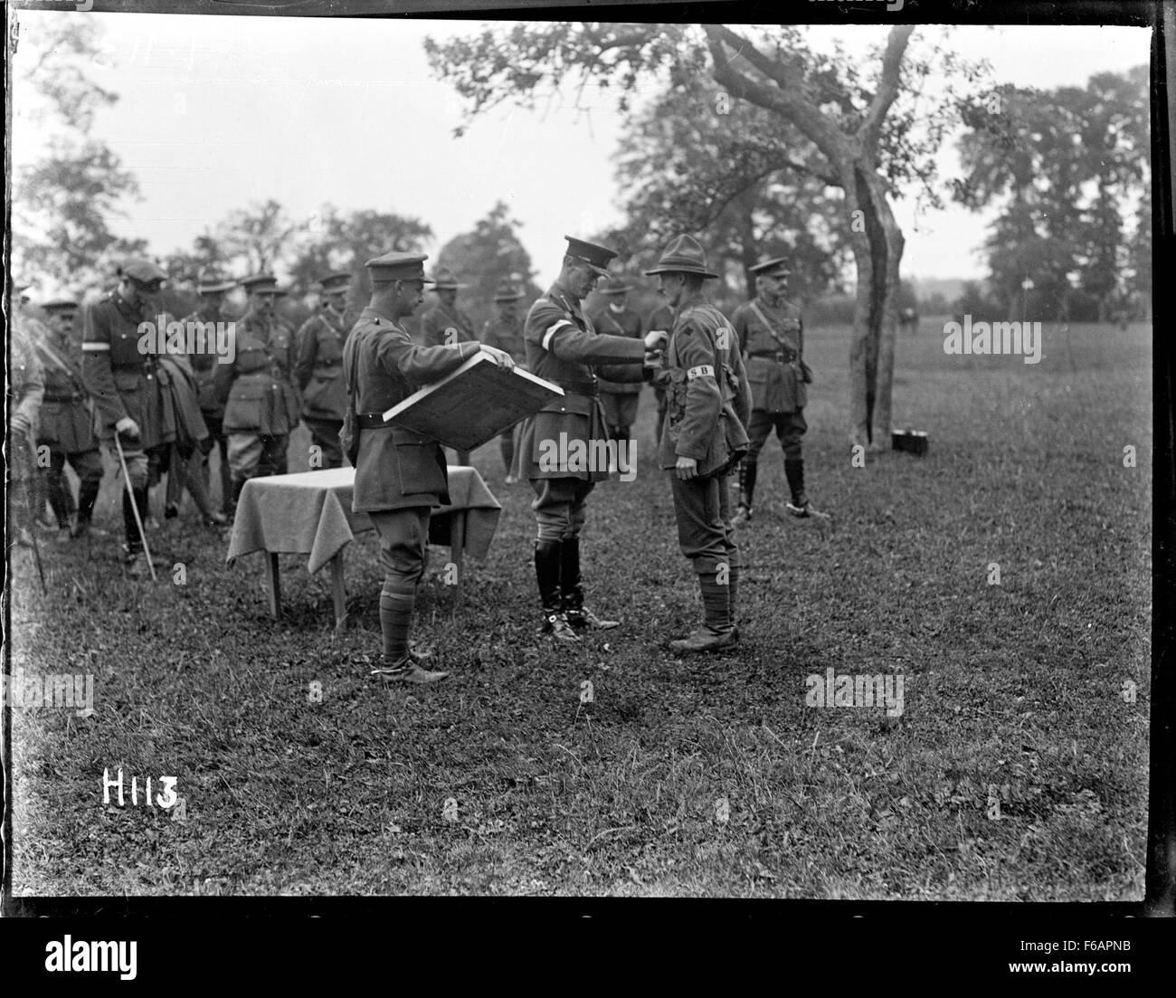 General Godley presents medals, likely in a military or ceremonial ...