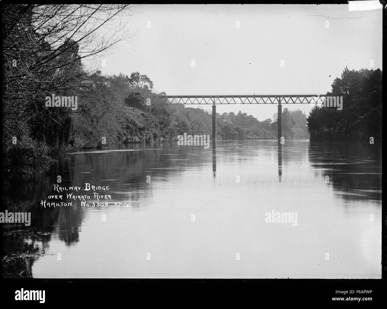 This historical photograph shows the railway bridge over the Waikato ...