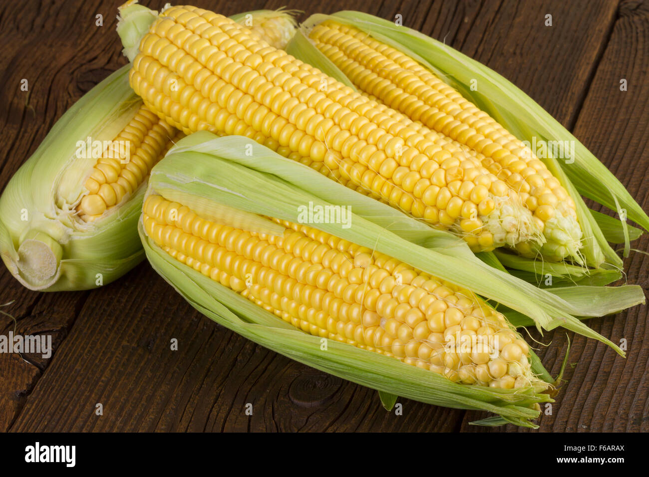 Corn on old wooden background Stock Photo - Alamy