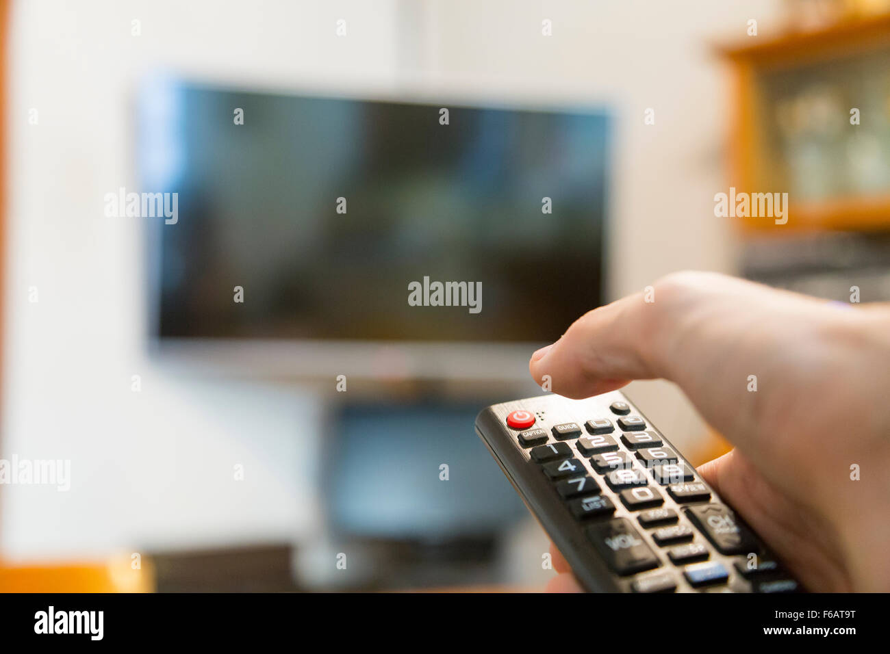 Person using remote control hi-res stock photography and images - Alamy