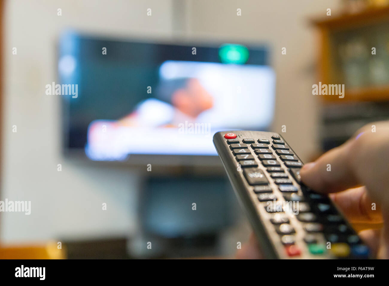 Person using remote control hi-res stock photography and images - Alamy