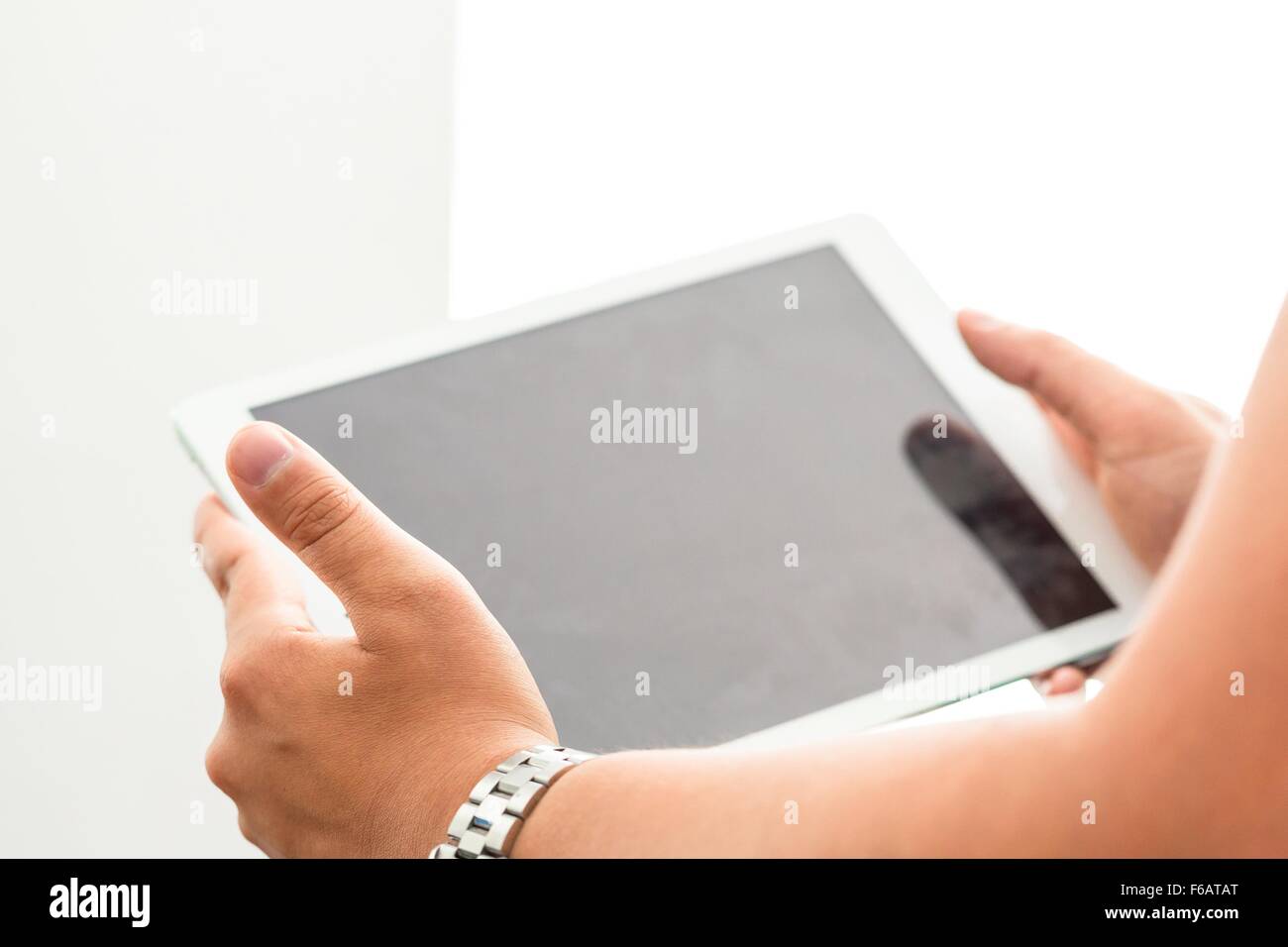 Tablet on hand Stock Photo - Alamy