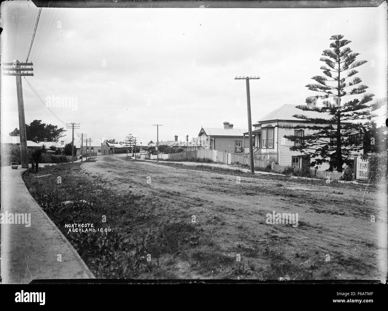 This historical photograph captures a view of Queen Street in Northcote ...