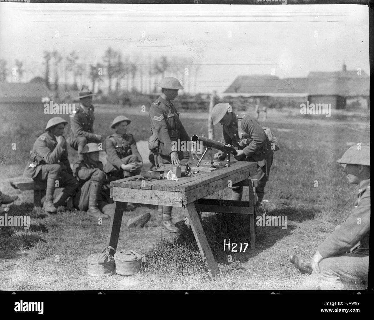 This historical photograph captures New Zealand soldiers operating a ...