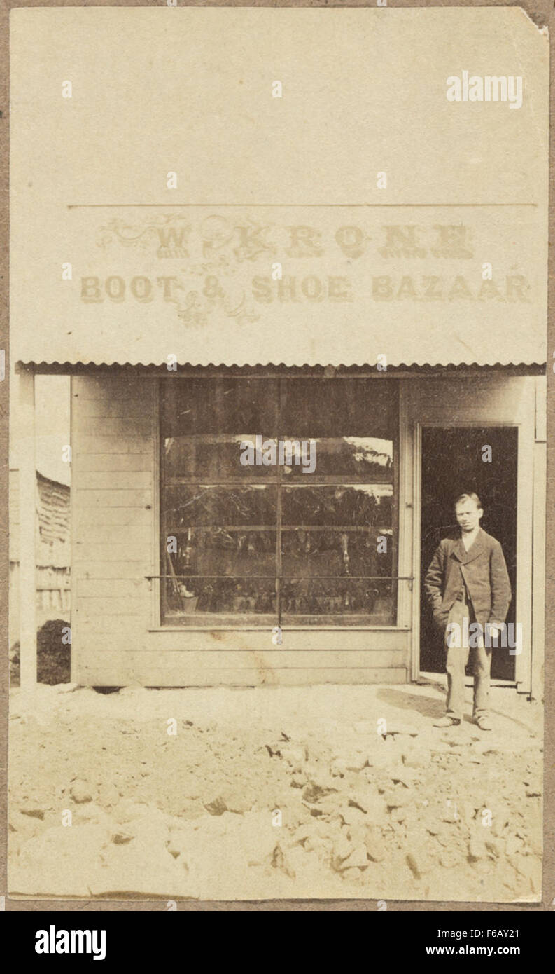 This photograph features a man standing outside William Krone's Boot ...