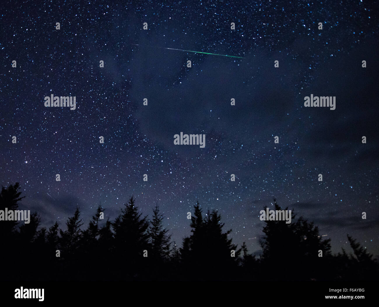 In this 20 second exposure, a meteor streaks across the sky during the ...
