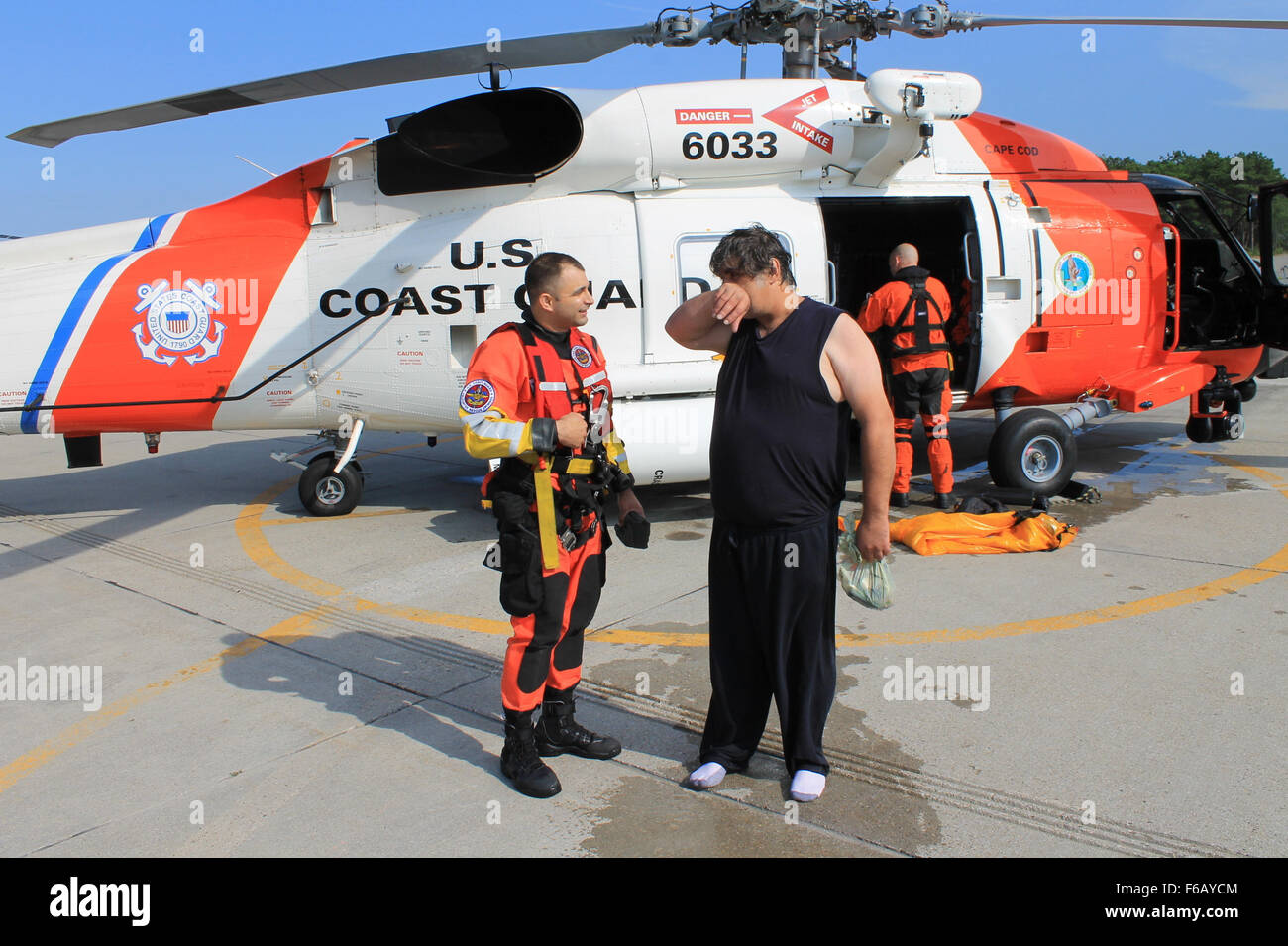 A Coast Guard helicopter rescue crew from Cape Cod, Mass., pulled three ...