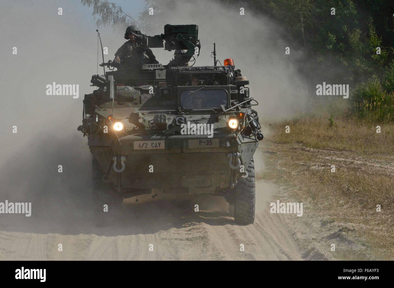 U.S. Soldiers assigned to a Stryker reconnaissance vehicle crew with ...