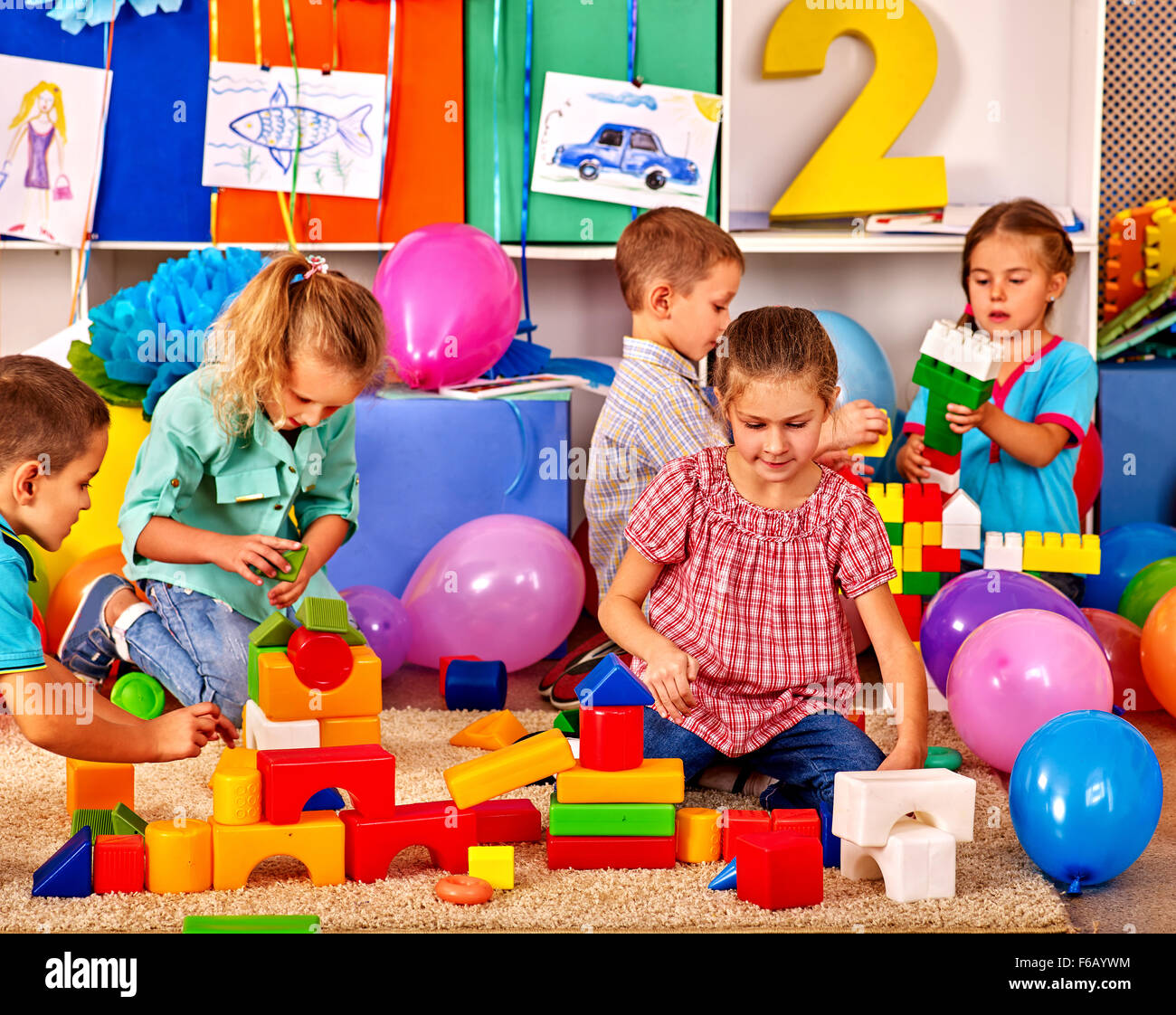 Group children game blocks on floor Stock Photo - Alamy