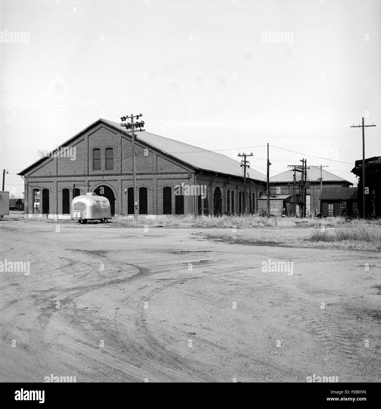 This image depicts the former locomotive shop building in Ennis, Texas ...