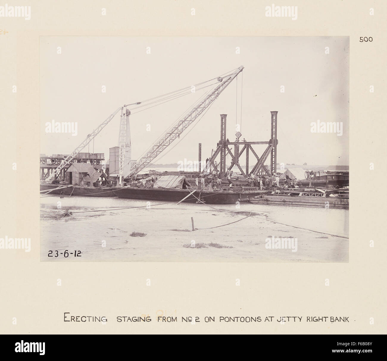 This photograph captures the construction process of a railroad bridge ...