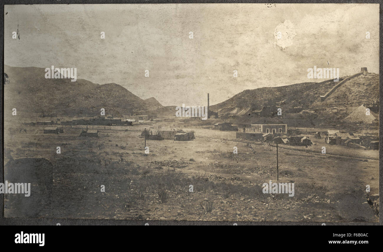 This photograph presents a general view of a mining town, with a focus ...