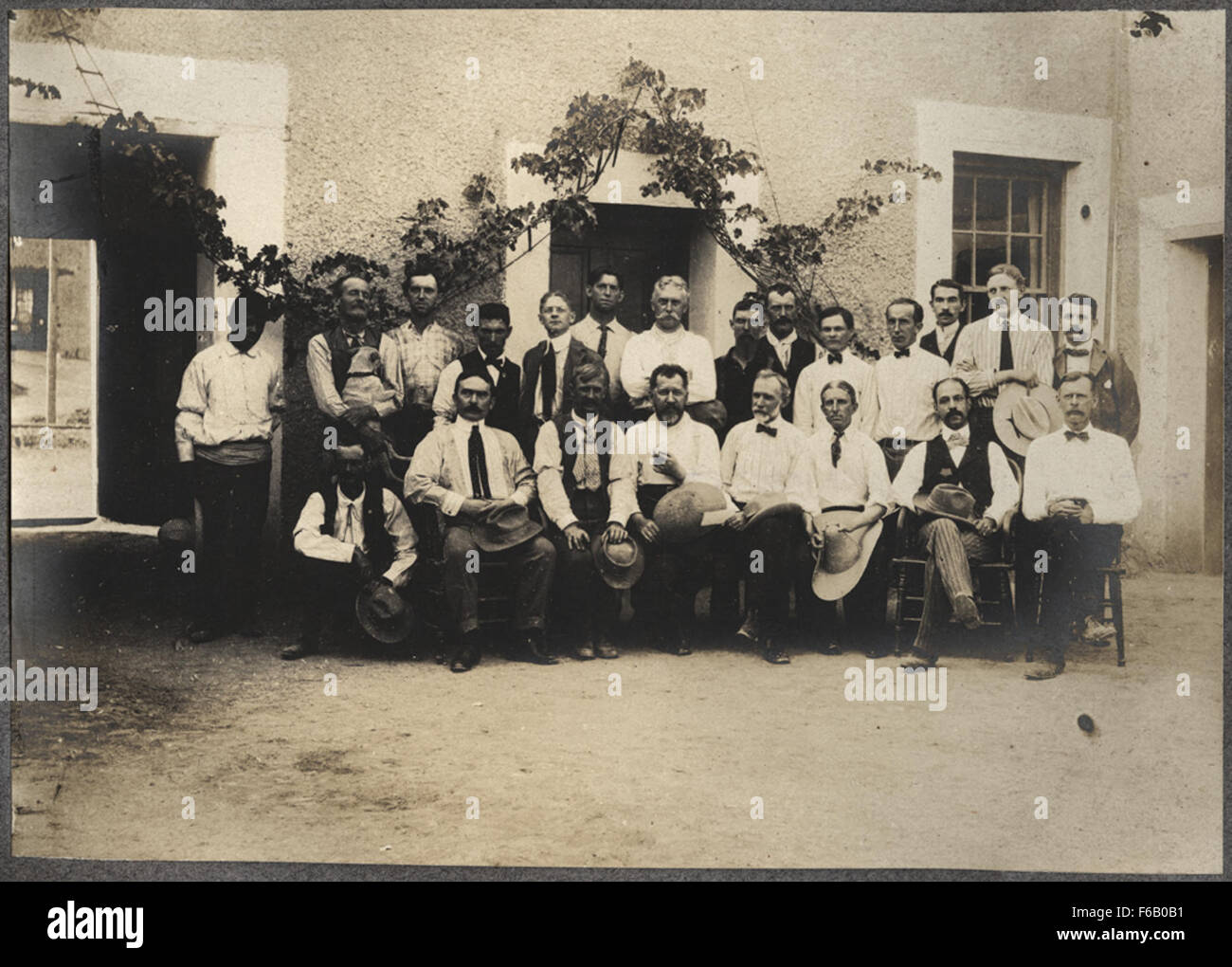 A photograph depicting a group of guests and mining workers, capturing ...