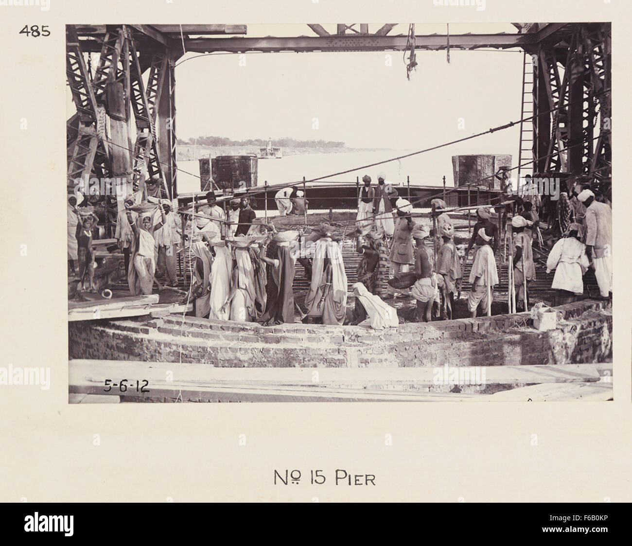 This historical photograph shows the construction of a railroad bridge ...