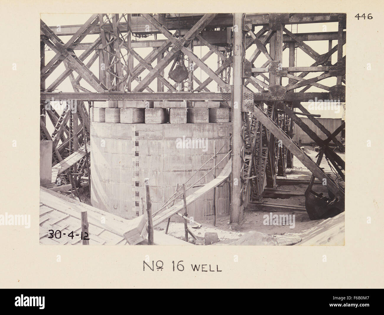 This historical image shows the construction of a railroad bridge ...