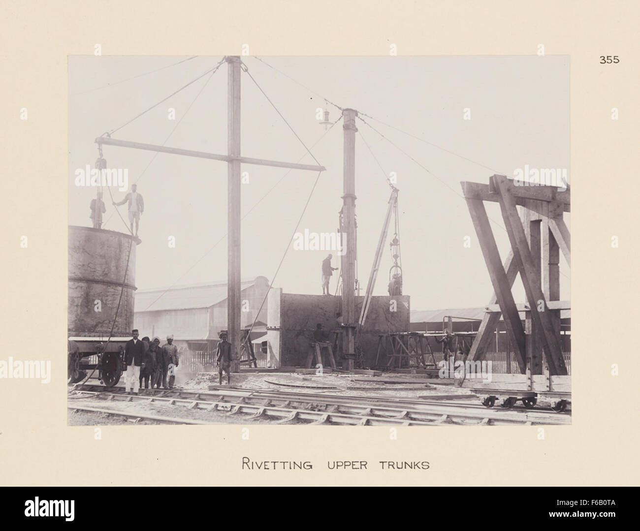 This historical photograph shows the riveting process involved in the ...