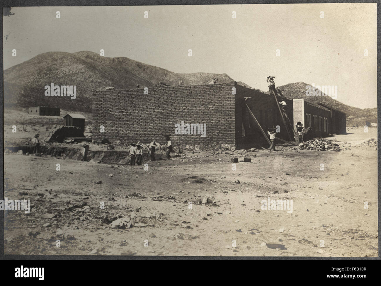 This photograph depicts native houses and mining buildings, showcasing ...