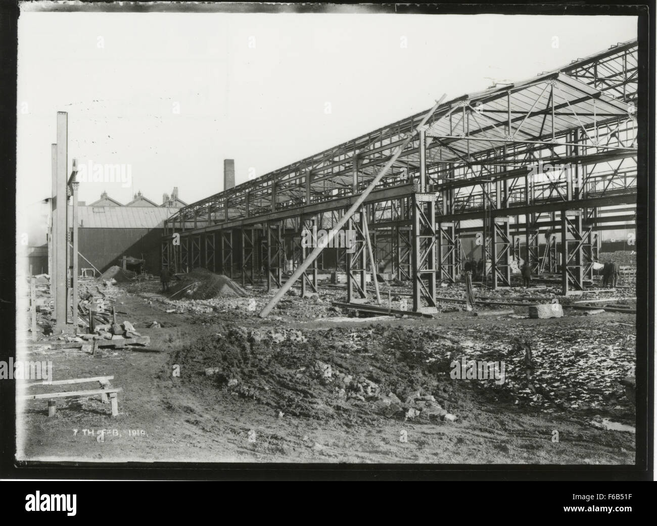 This historical photograph captures the construction of a building in ...