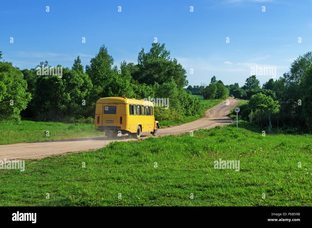 Rural road with yellow school bus Stock Photo - Alamy