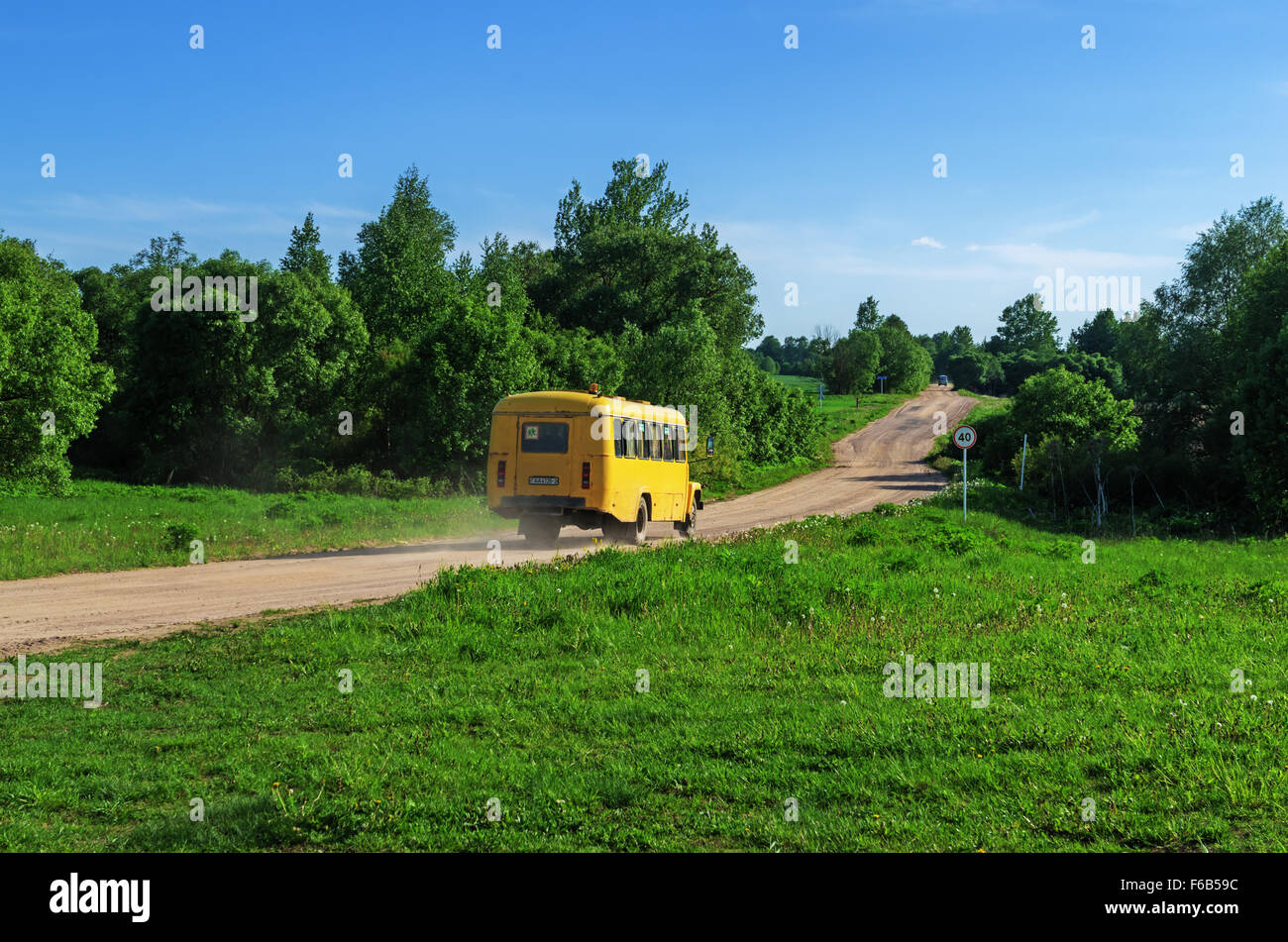 Rural road with yellow school bus Stock Photo - Alamy