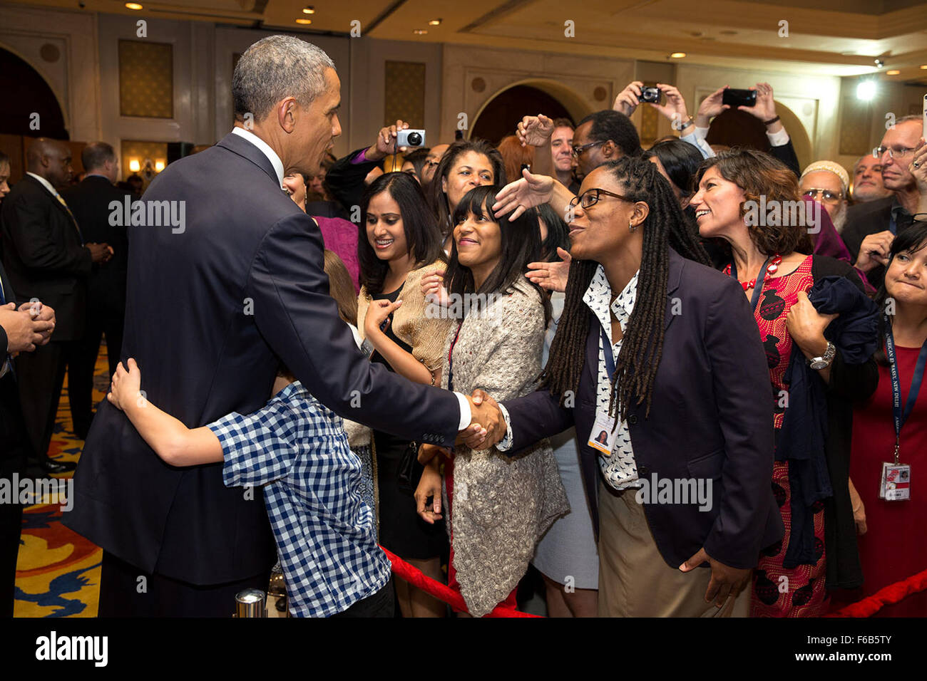 A young boy hugs President Barack Obama as he greets U.S. Embassy ...