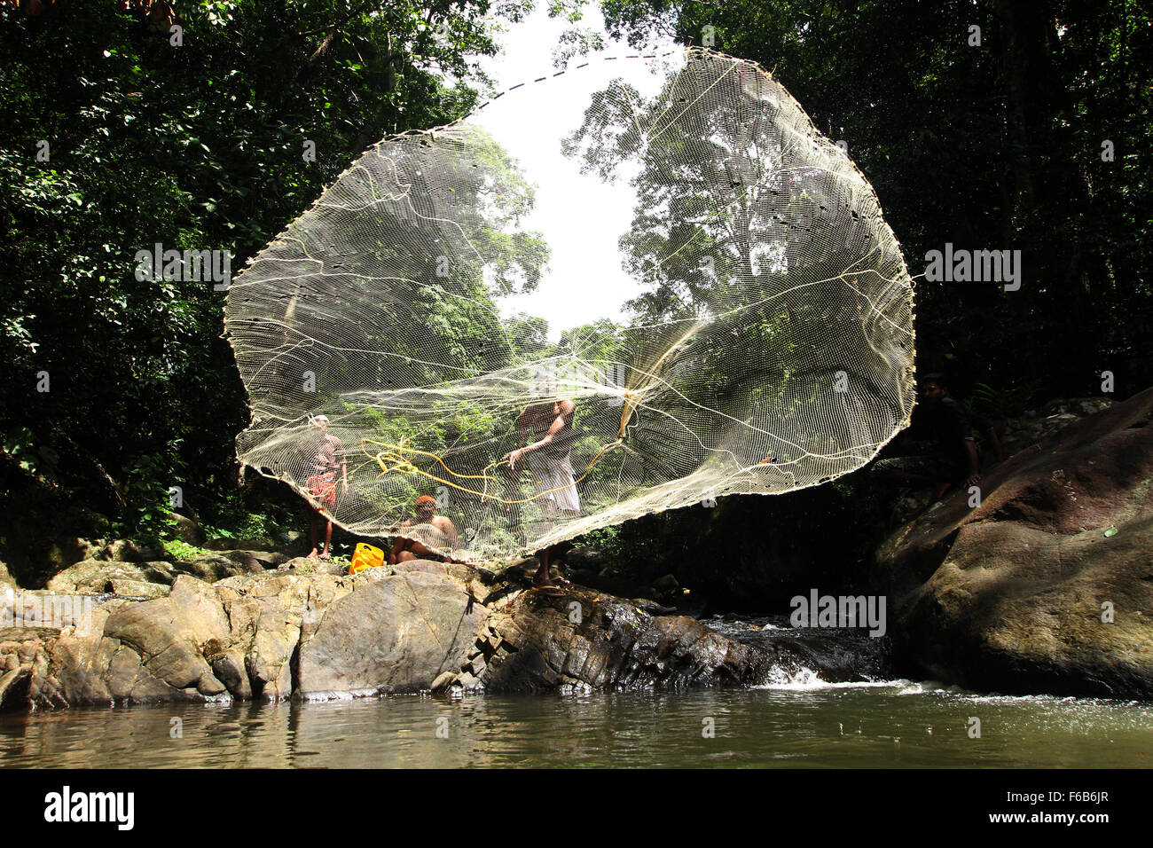 A fisherman throwing out fishing net Stock Photo - Alamy