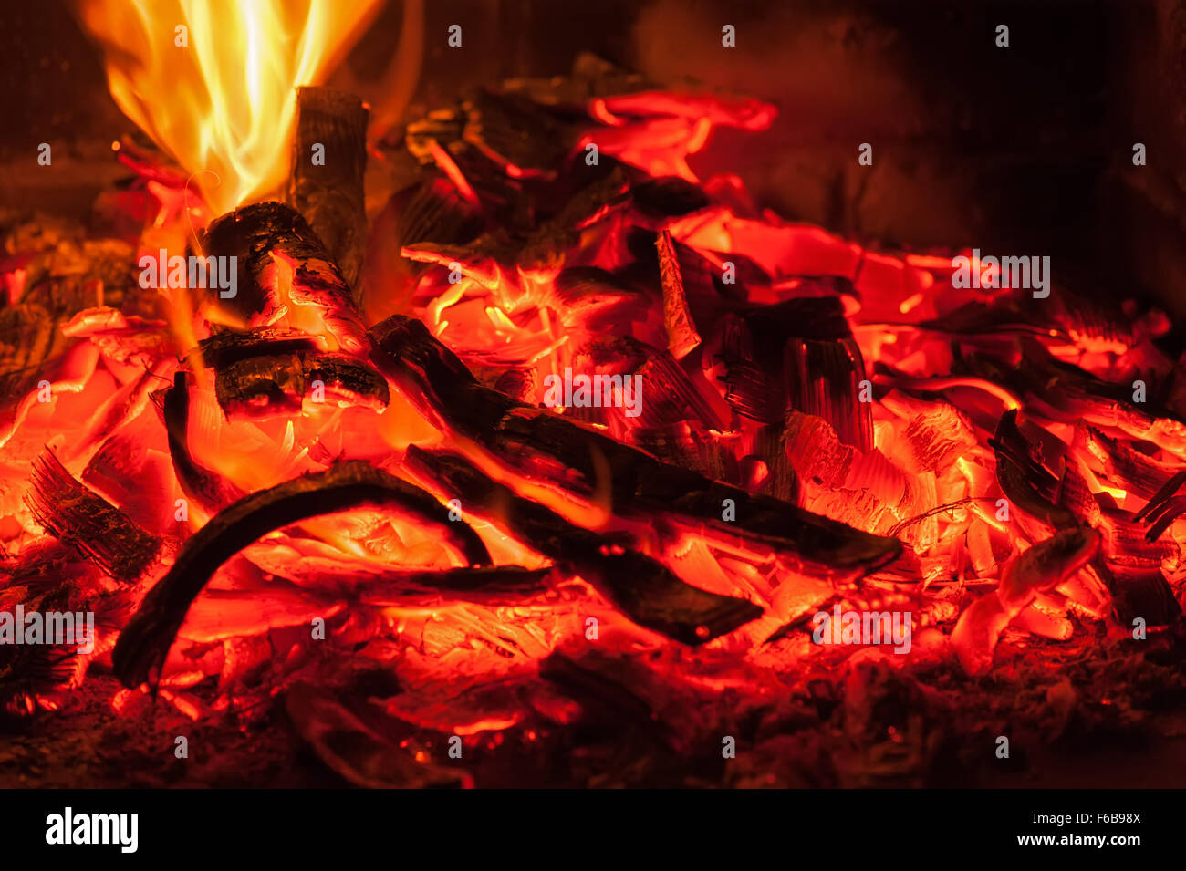 Open fire in fireplace. Closeup of burning stack of firewood with ...