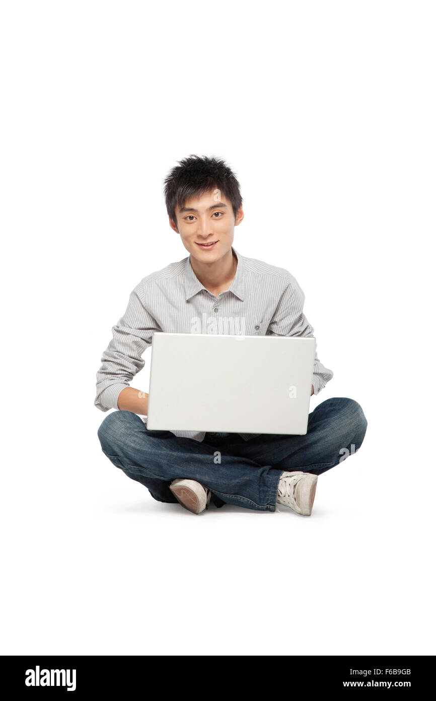 Young man using a laptop computer Stock Photo - Alamy